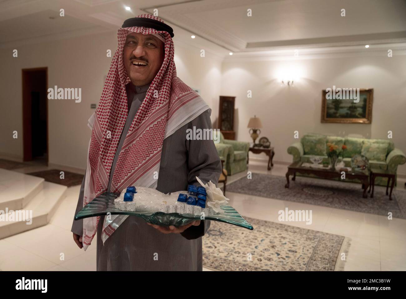 Former opposition leader Musallam al-Barrak holds a tray of sweets for ...