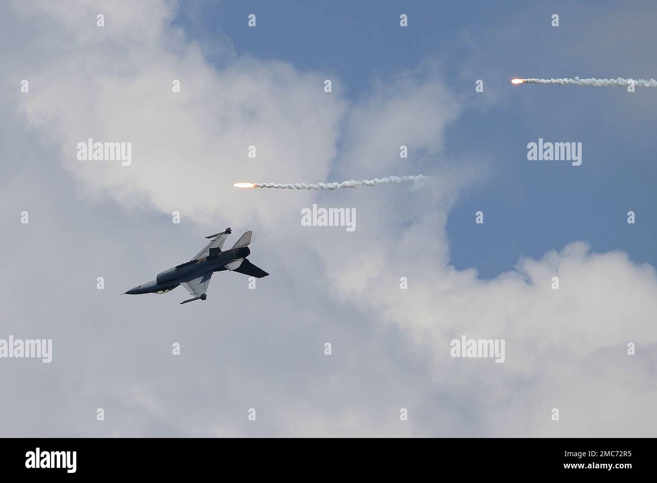 A Republic of Singapore Air Force (RSAF) F-16C fighter jetreleases flares while performing an ...