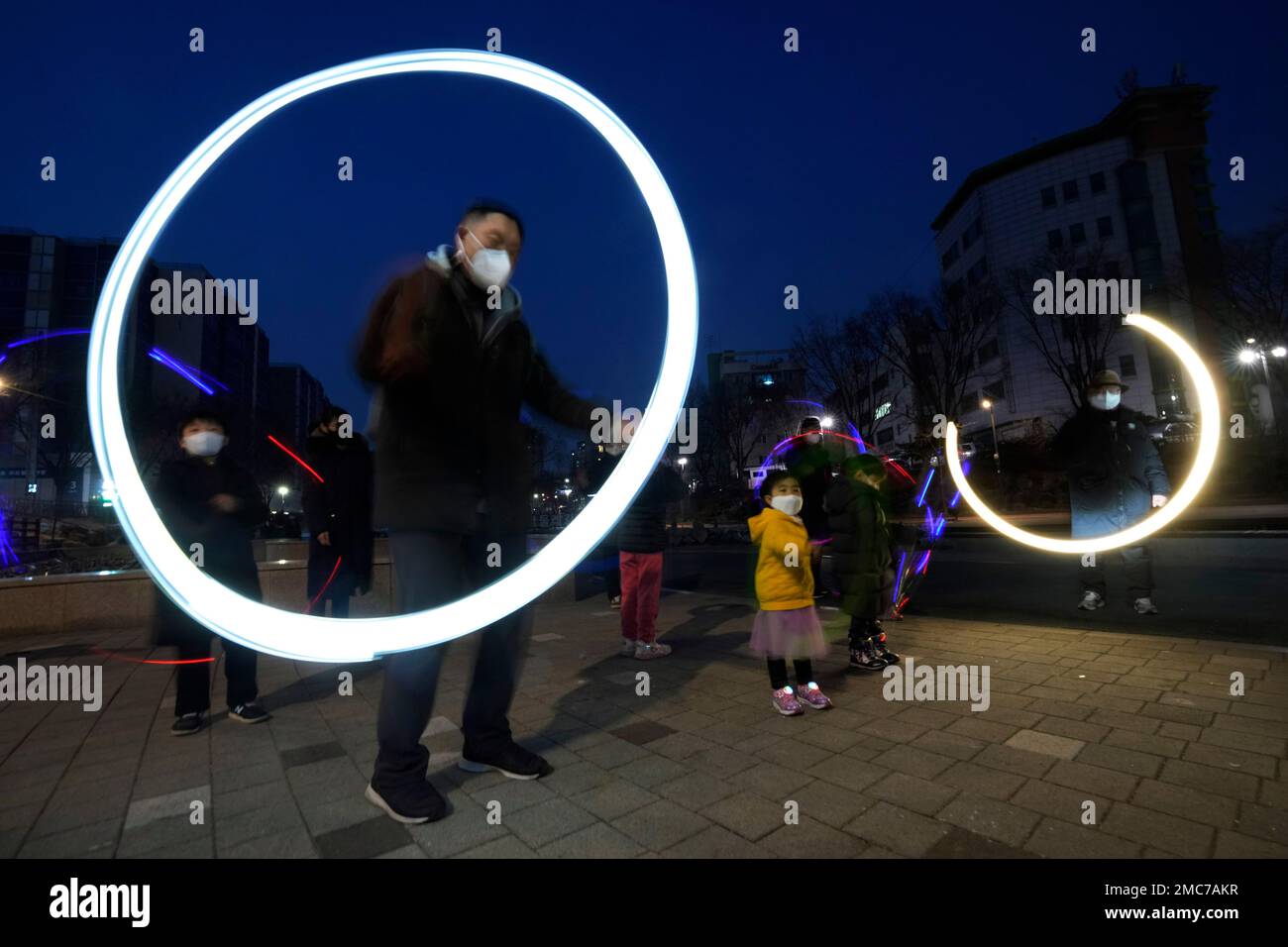People whirl cans with LED lamps around to celebrate the upcoming first ...