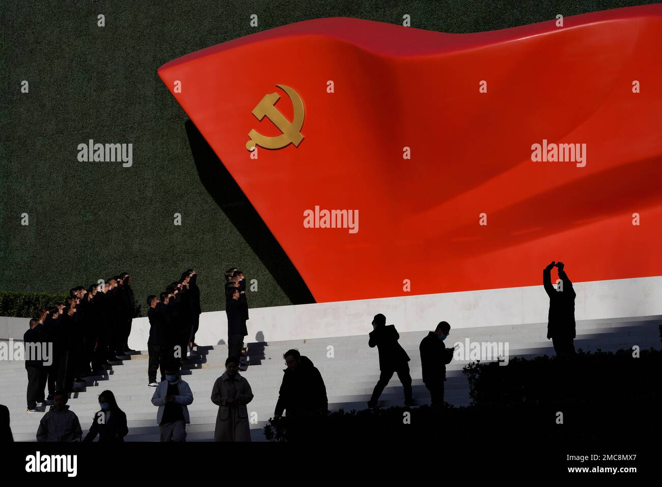 FILE - Chinese Communist Party members pose for photos with a sculpture ...