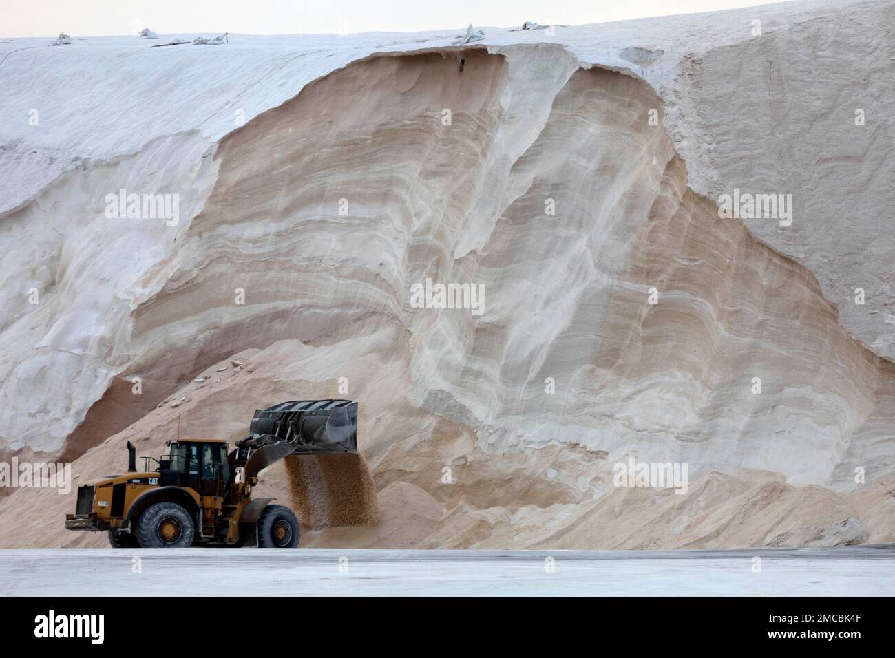 A front-end loader works in front of a pile of road salt, Friday, Jan ...
