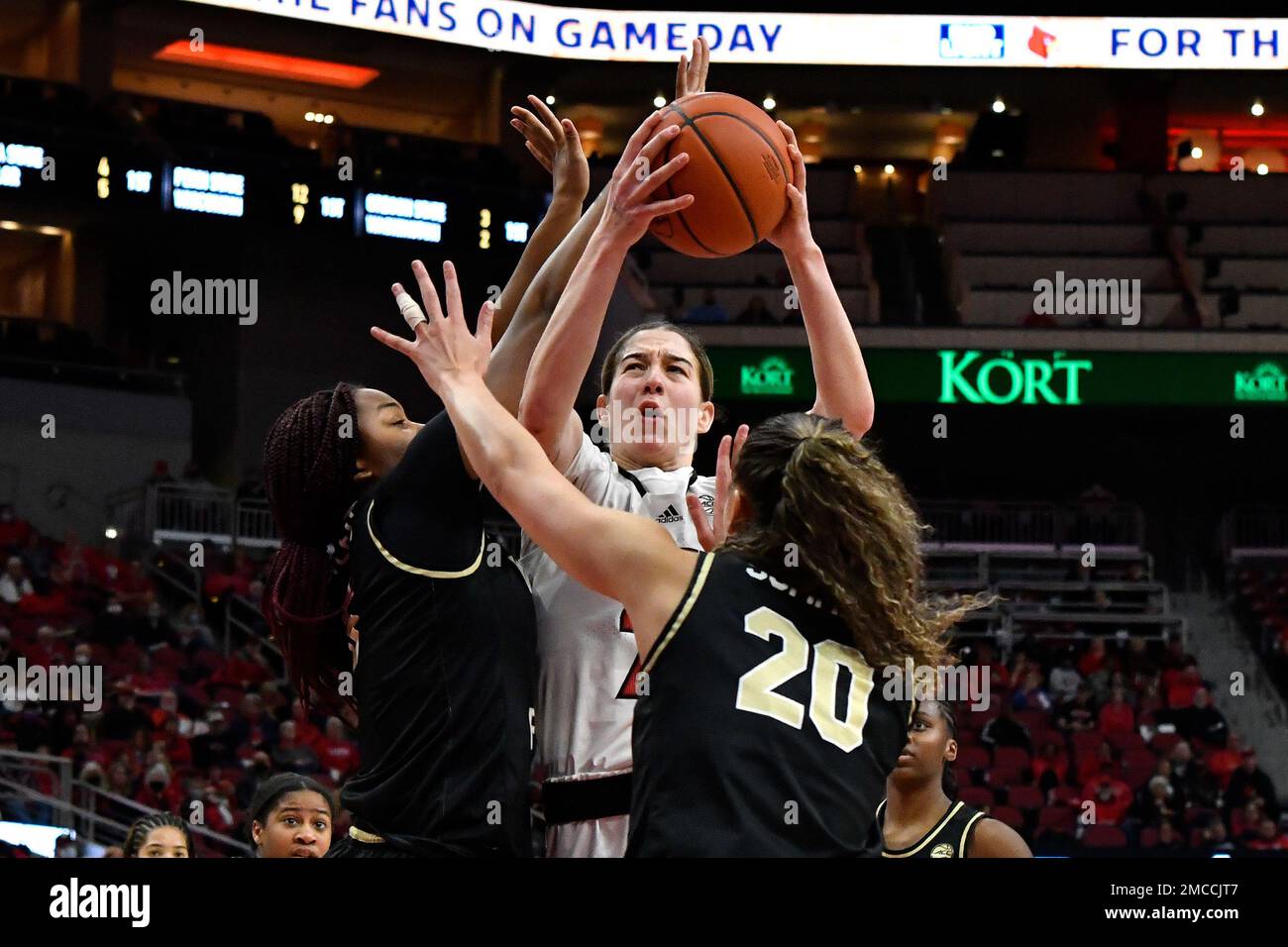 Louisville forward Emily Engstler (21) shoots over Wake Forest forwards ...