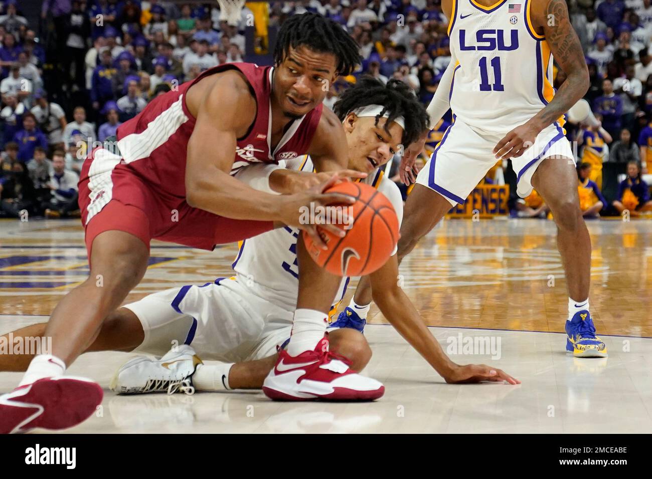 Arkansas guard Stanley Umude, left, and LSU forward Alex Fudge battle ...
