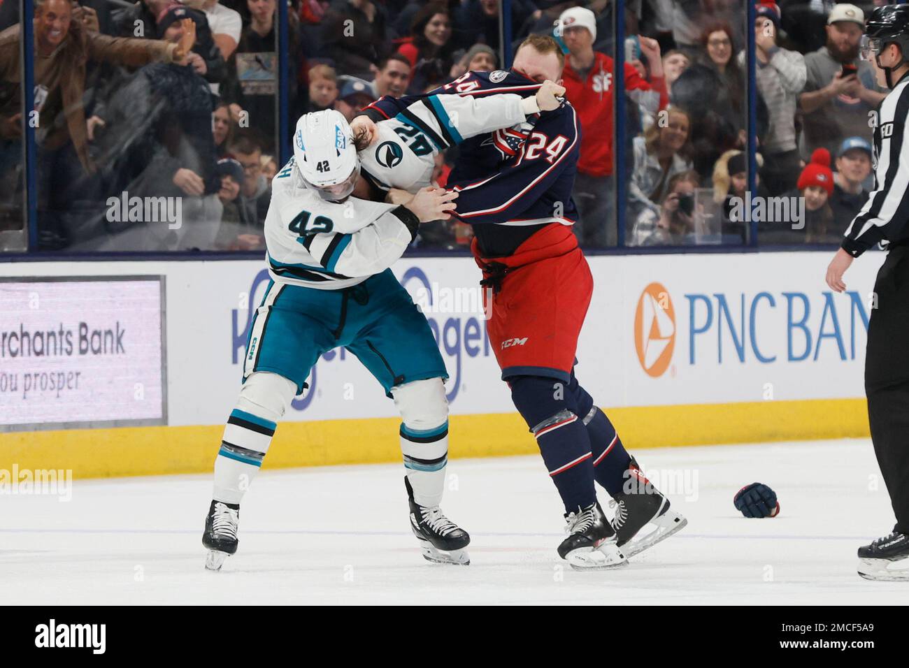 San Jose Sharks' Jonah Gadjovich, left, and Columbus Blue Jackets ...