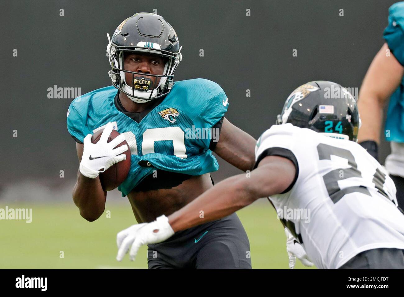 FILE - Jacksonville Jaguars running back Ryquell Armstead, left, tries ...
