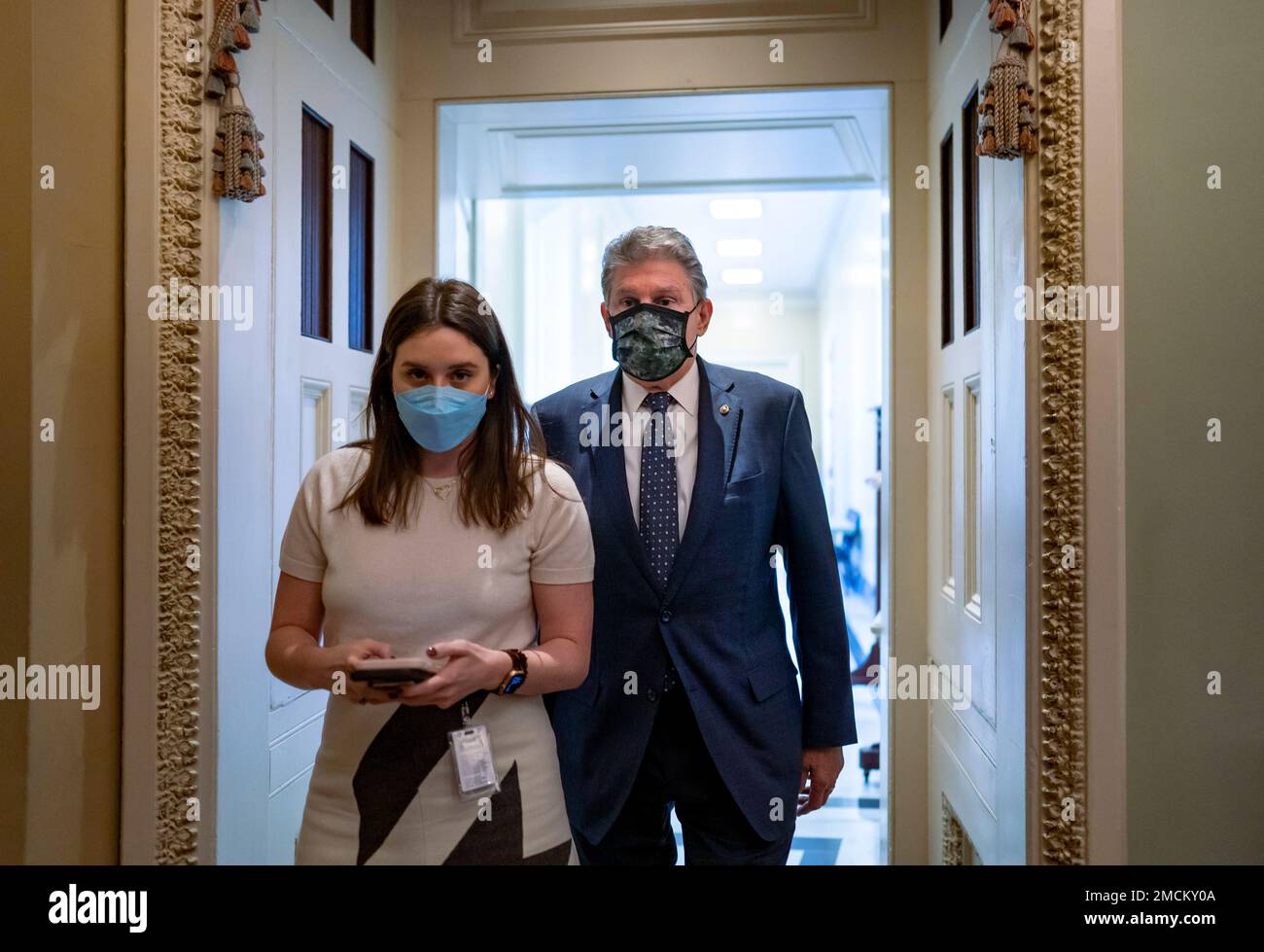 Sen. Joe Manchin, D-W.Va., rushes past reporters after attending a ...
