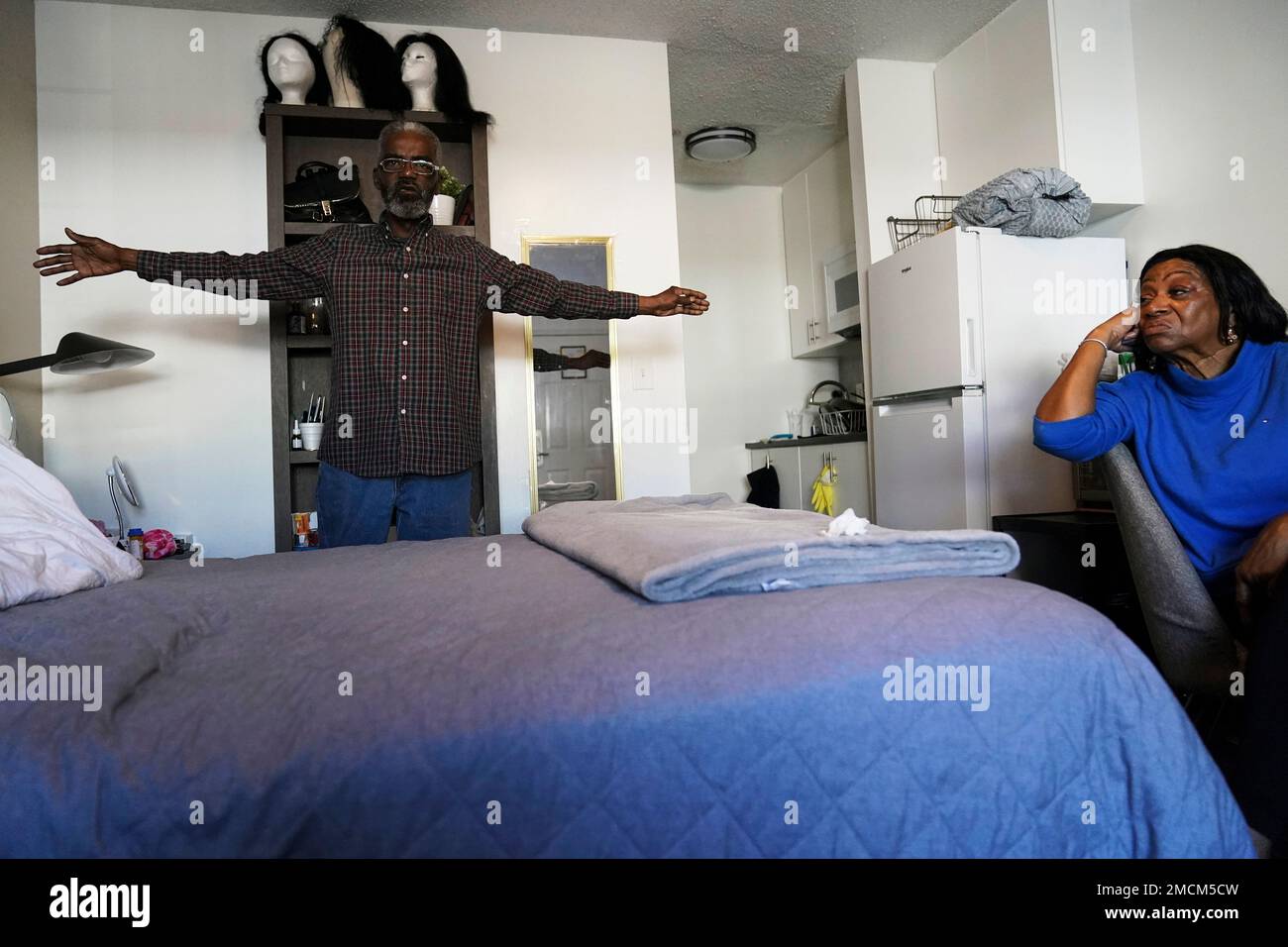 Faye Moore, right, and her partner Garry Betared, left, talk about ...