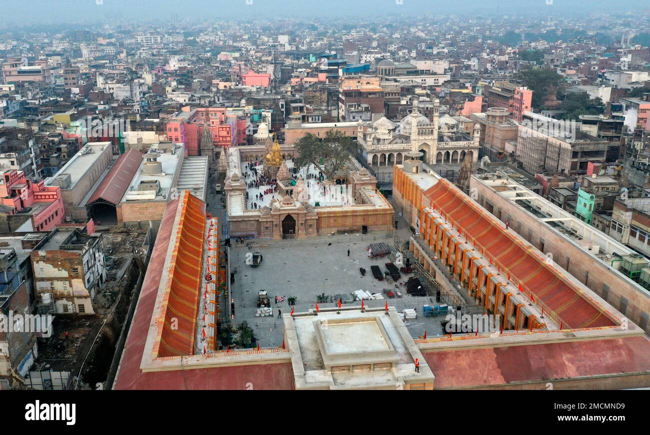Devotees offer prayers at the Kashi Vishwanath temple, center, as newly constructed structures ...