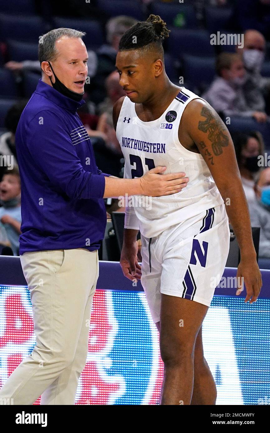 Northwestern head coach Chris Collins, left, talks with forward Elyjah ...