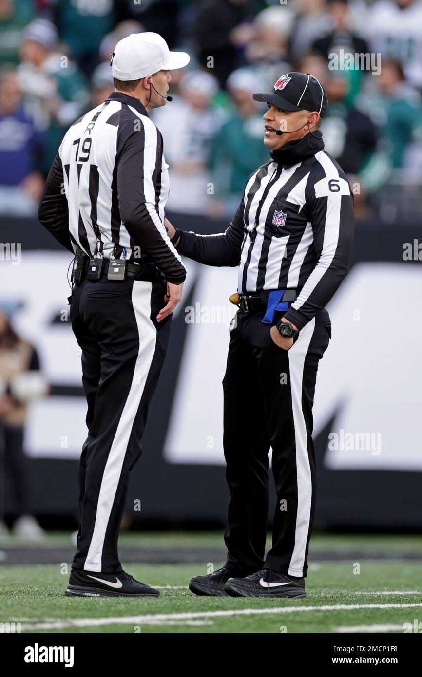 Referee Clay Martin (19) talks to down judge Jerod Phillips (6) during ...