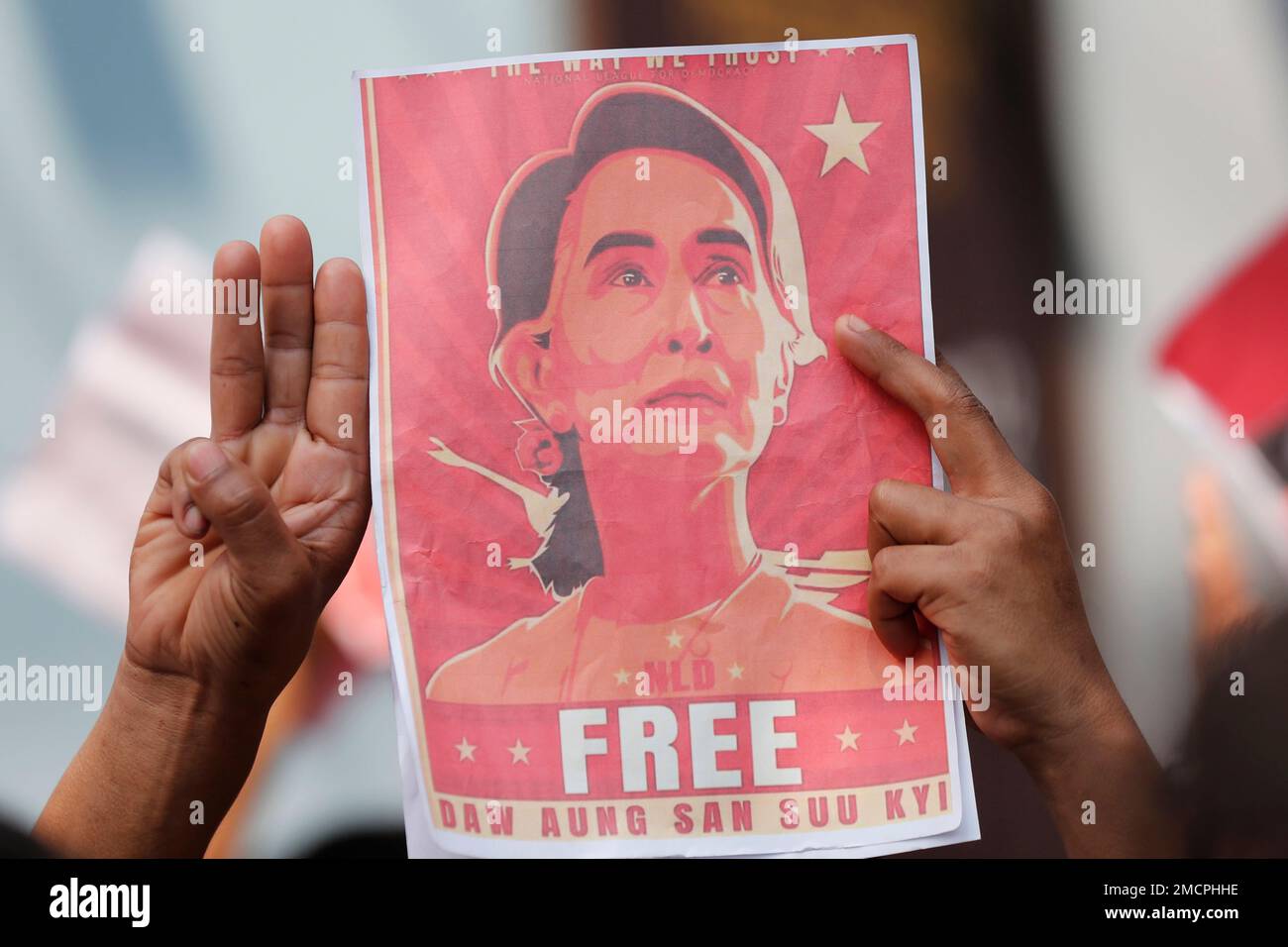 FILE - Myanmar nationals living in Thailand hold pictures of Myanmar ...