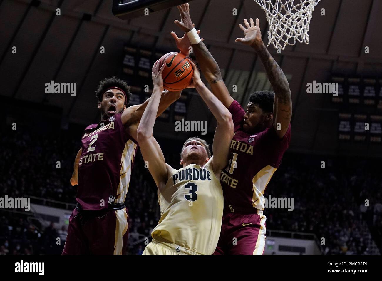 Purdue forward Caleb Furst (3) is floe das he shoots between Florida ...