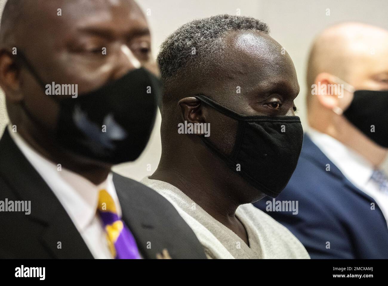 Ahmaud Arbery's father Marcus Arbery, center, listens to closing ...