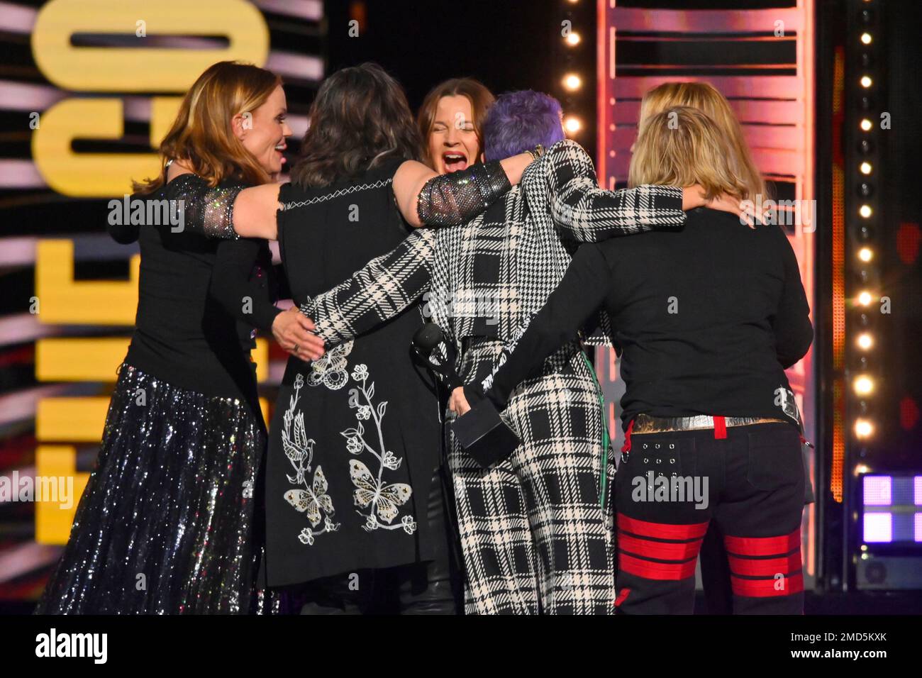 The Go-Go's hug their presenter, actress Drew Barrymore, after she ...