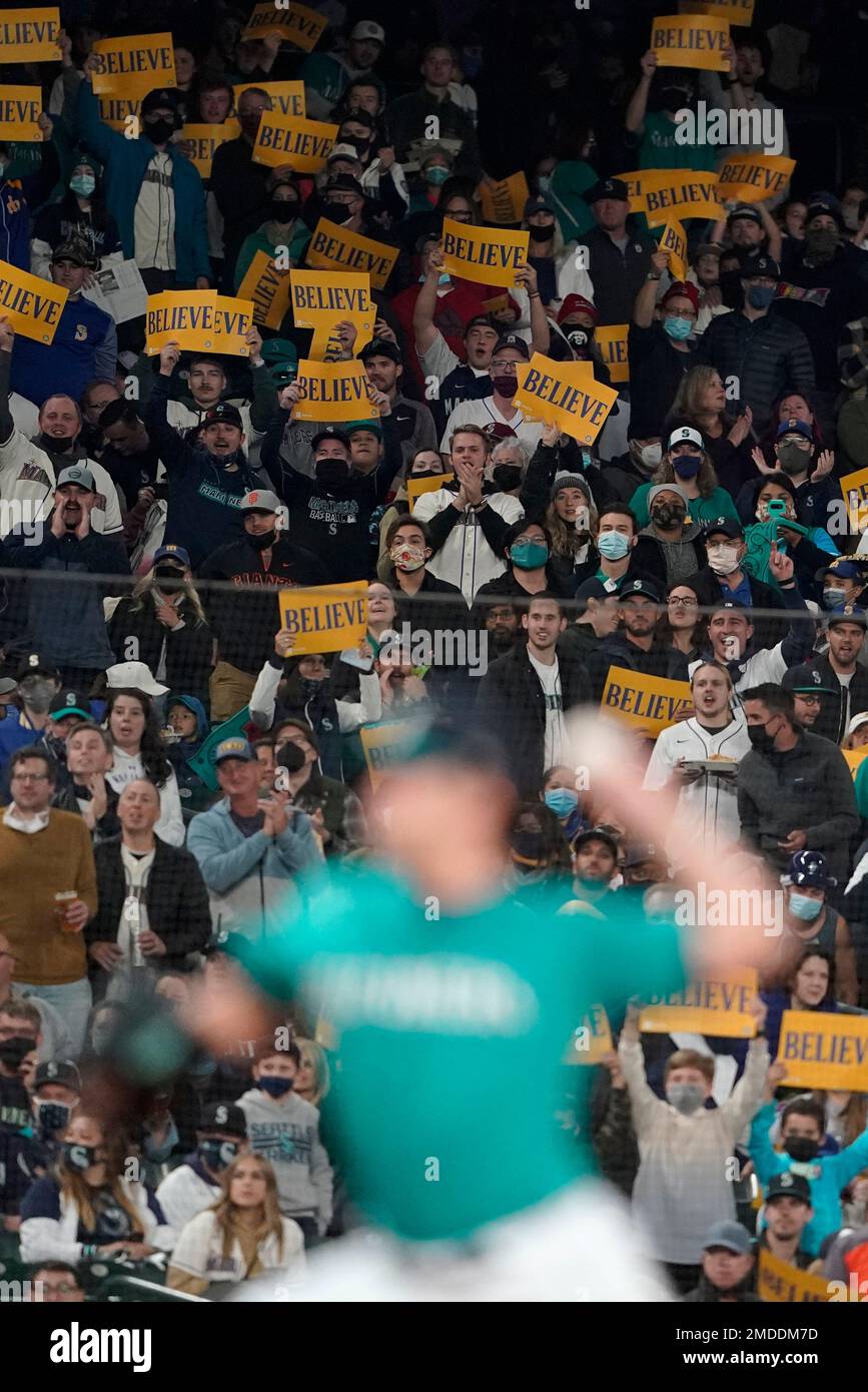 Fans hold up signs that read "Believe" as Seattle Mariners starting ...