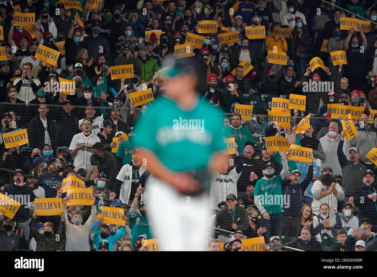 Fans hold up signs that read "Believe" as Seattle Mariners starting ...