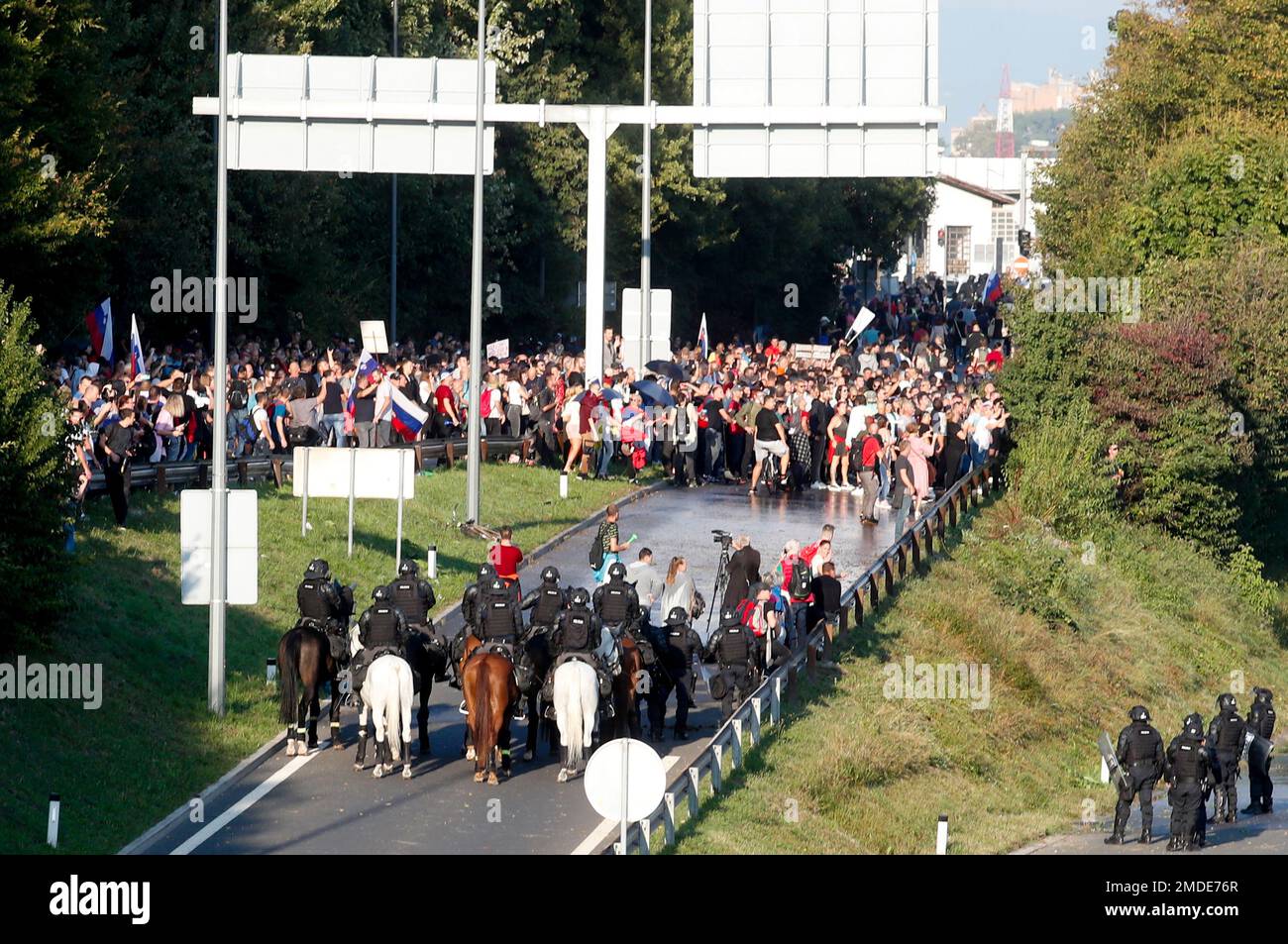 Riot police officers block the road during a protest against ...