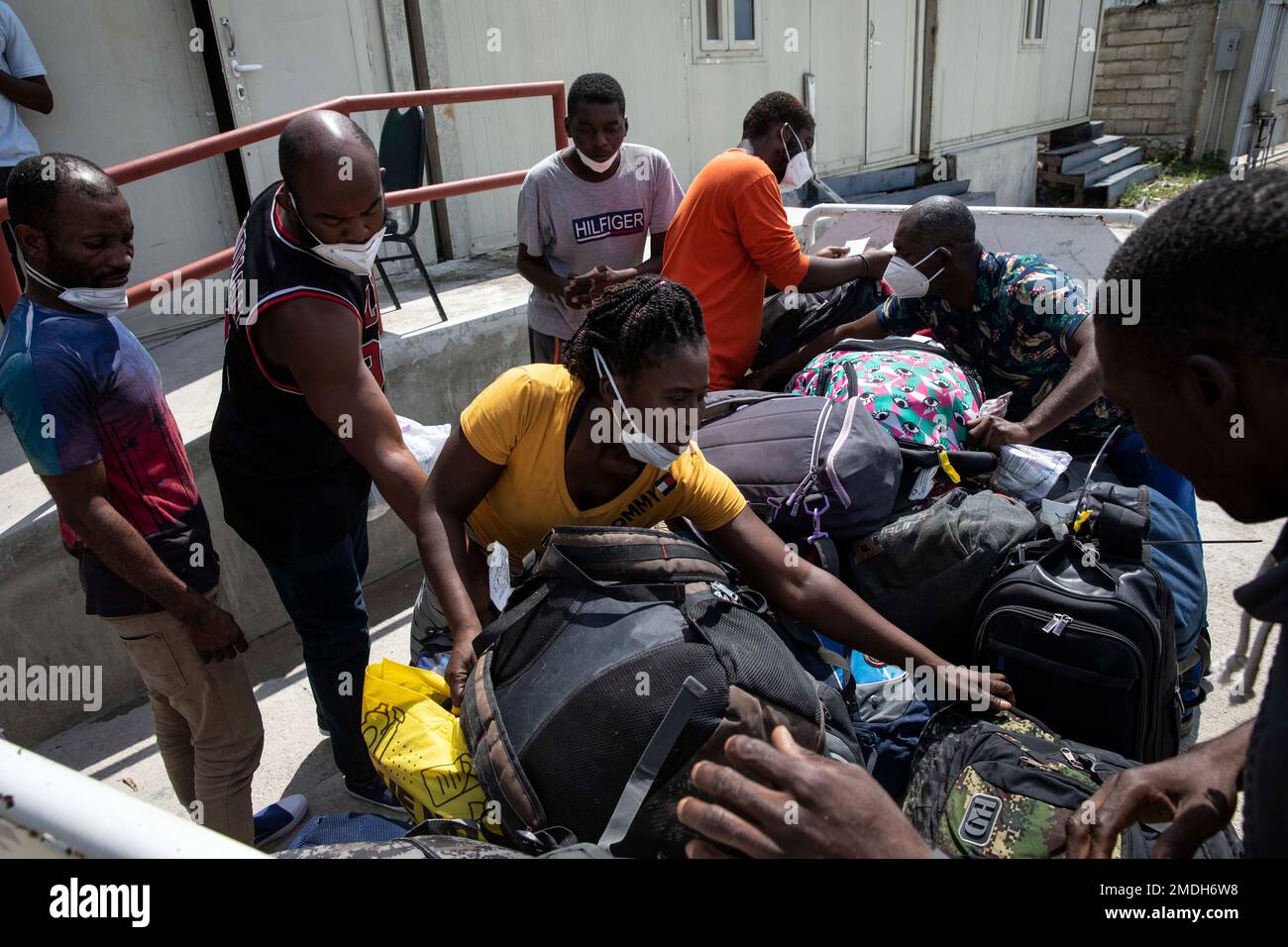Haitian migrants deported from the US pick up their luggage at the ...