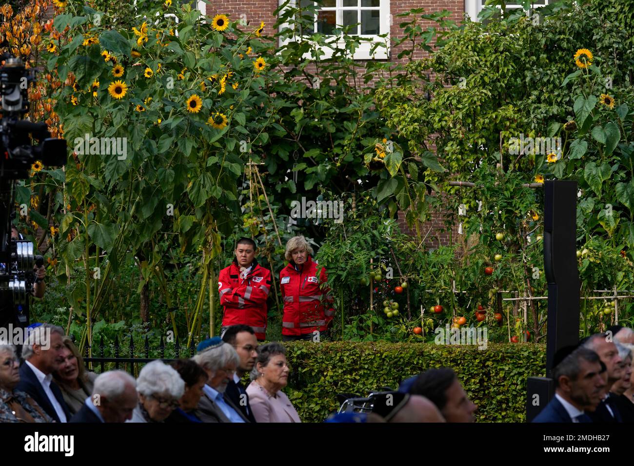 Rescue workers watch a ceremony where King Willem-Alexander officially ...