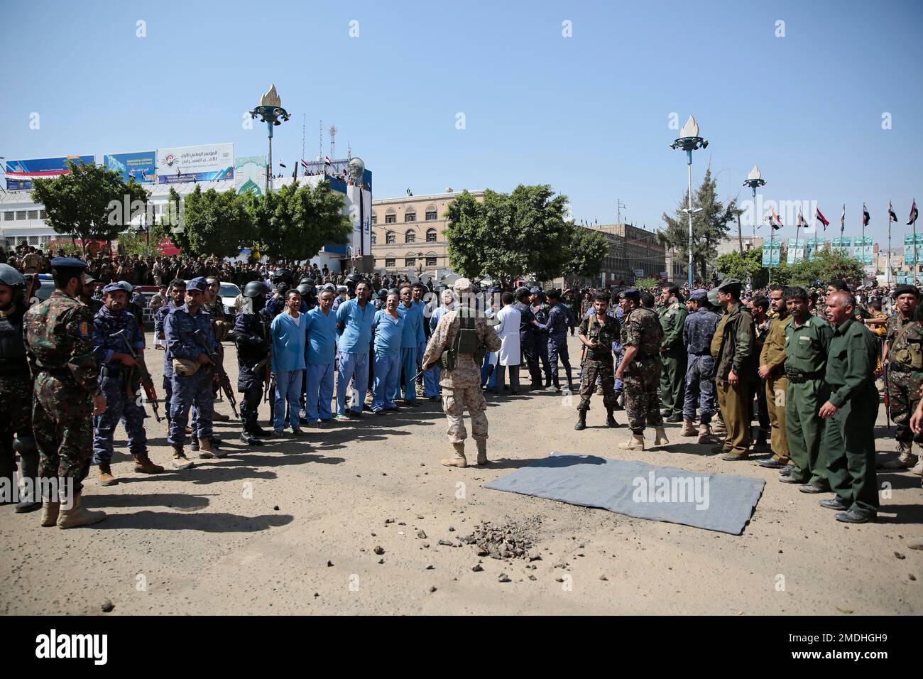 Police troopers stand guard next to men convicted of involvement in the ...