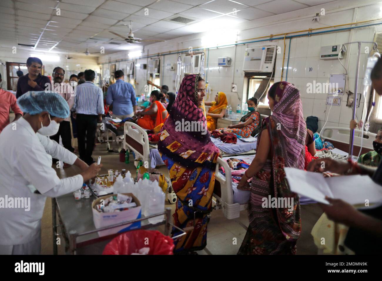 Children suffering from various ailments and their relatives crowd a ...