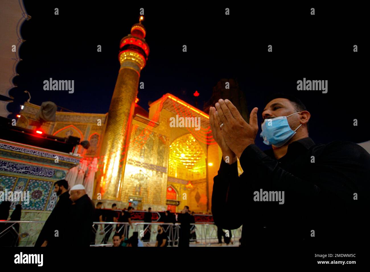 Shiite faithful pilgrims pray inside the holy shrine of Imam Ali, the ...