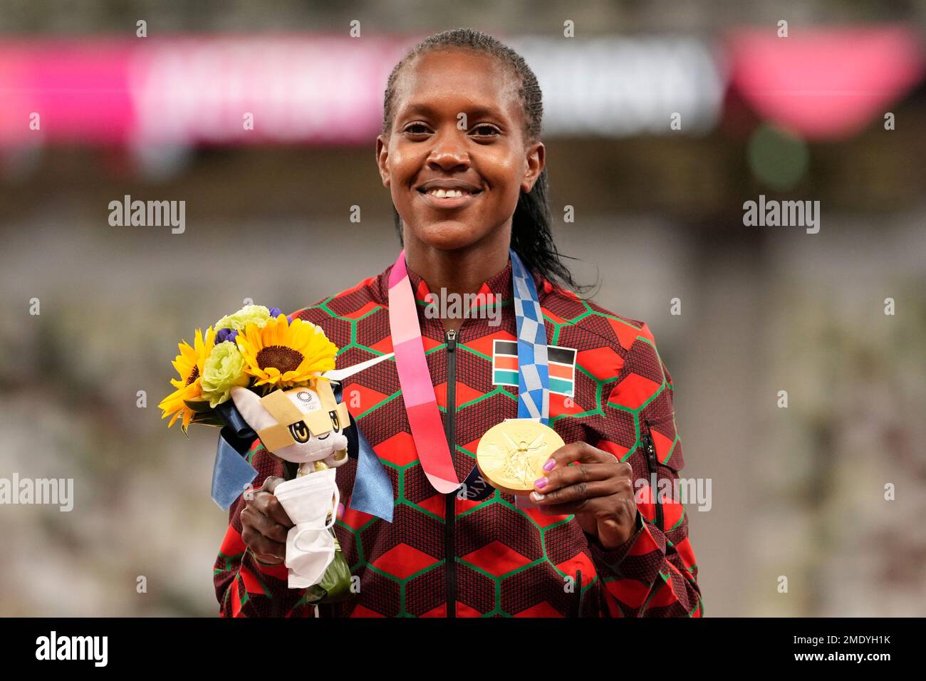 Gold medalist Faith Kipyegon, of Kenya poses during the medal ceremony ...