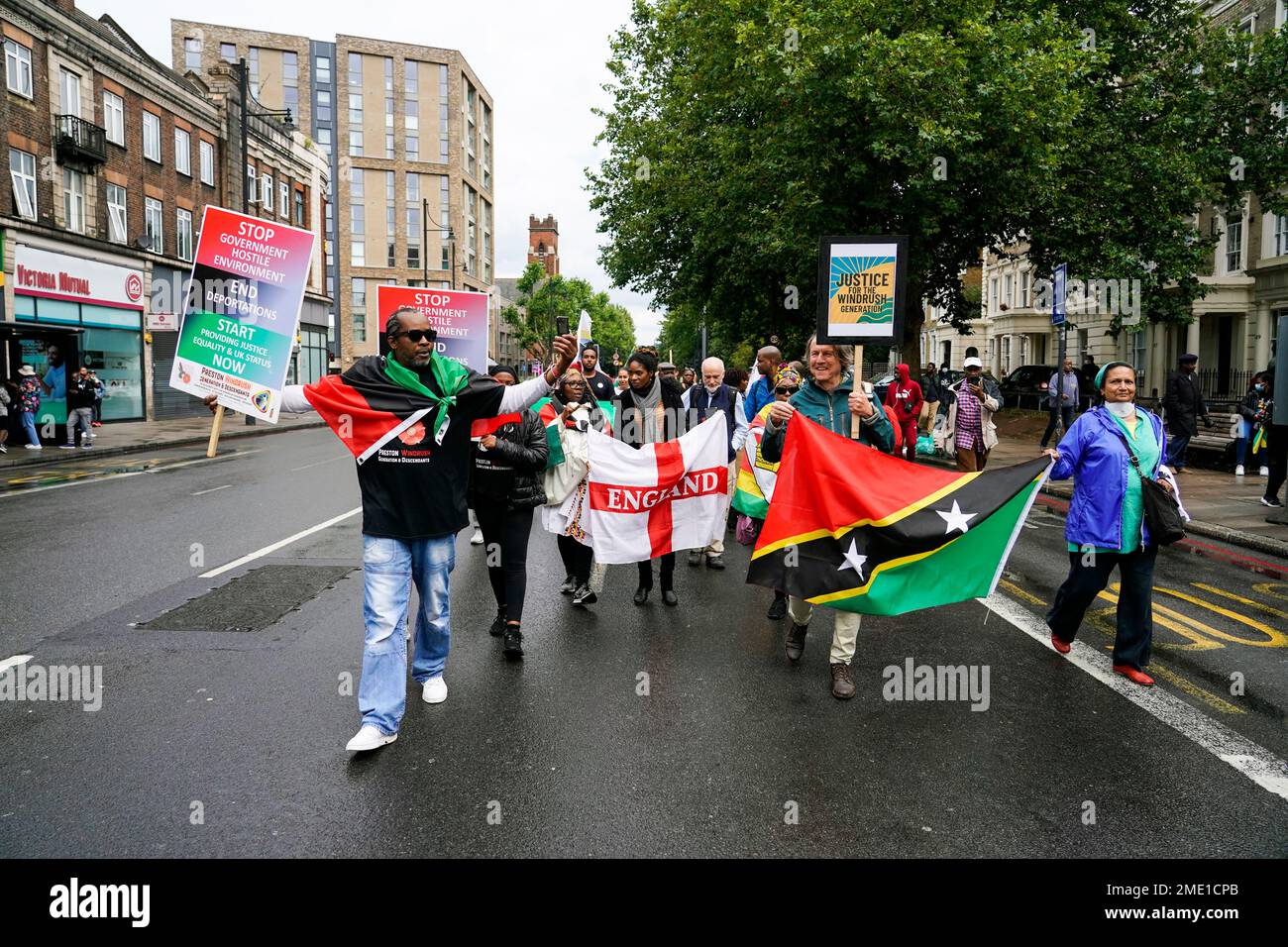 Demonstrators hold flags and placards as they take part in the annual ...