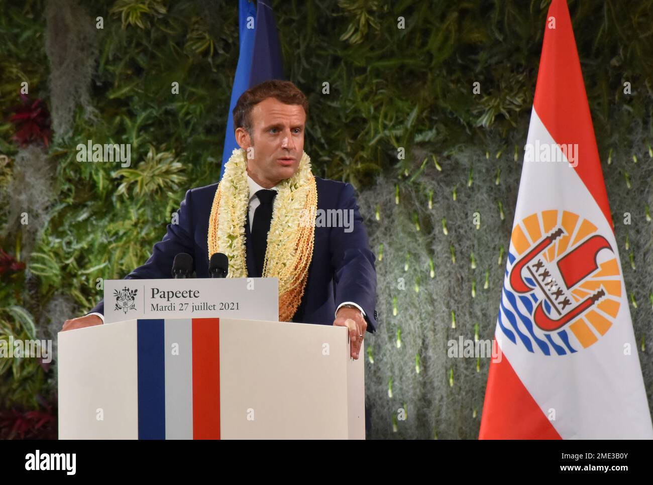 France's President Emmanuel Macron wearing a flower lei and seashell ...