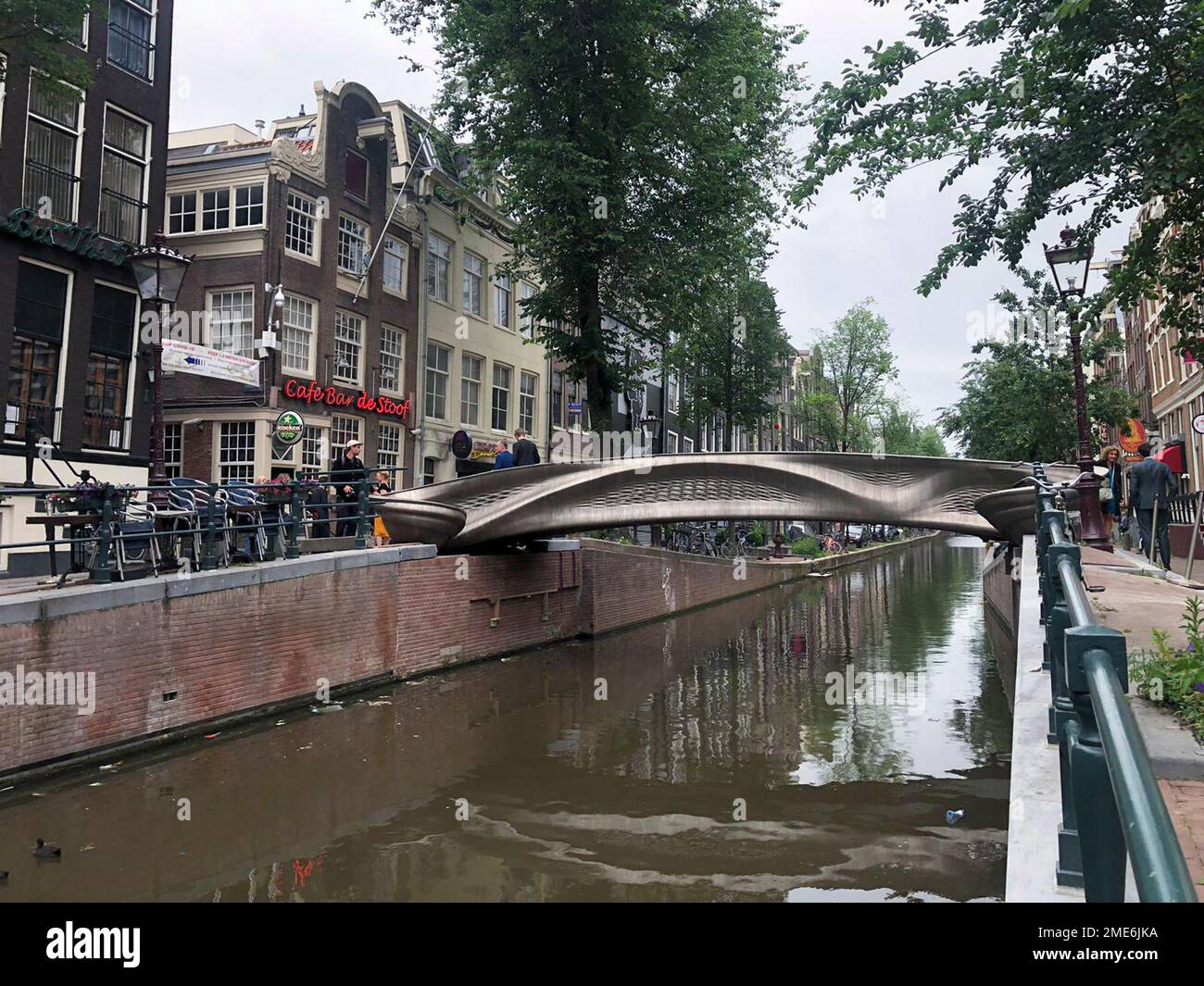 A steel 3D-printed pedestrian bridge spans a canal in the heart of the ...