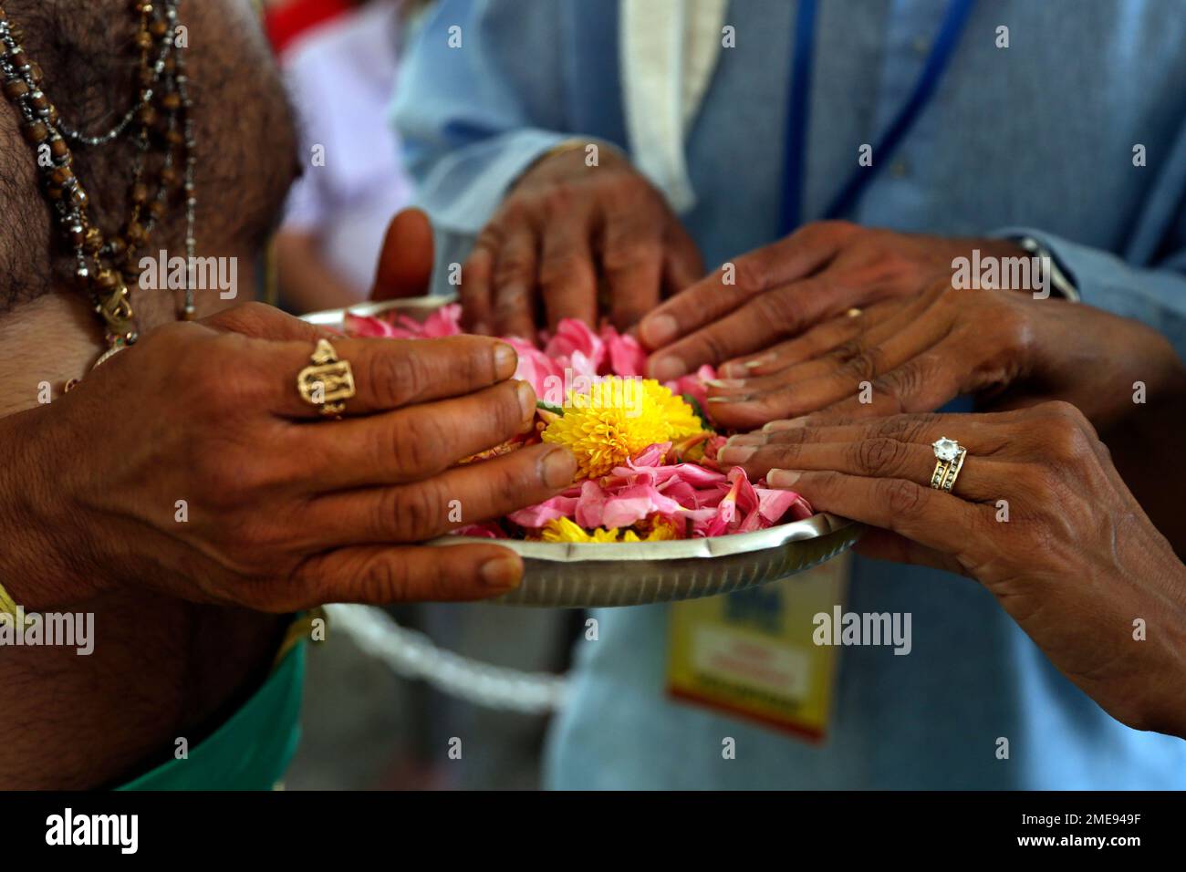 Hindu priest Gopala Dhattar, left, gives blessings to Pandu Tadikamalla ...