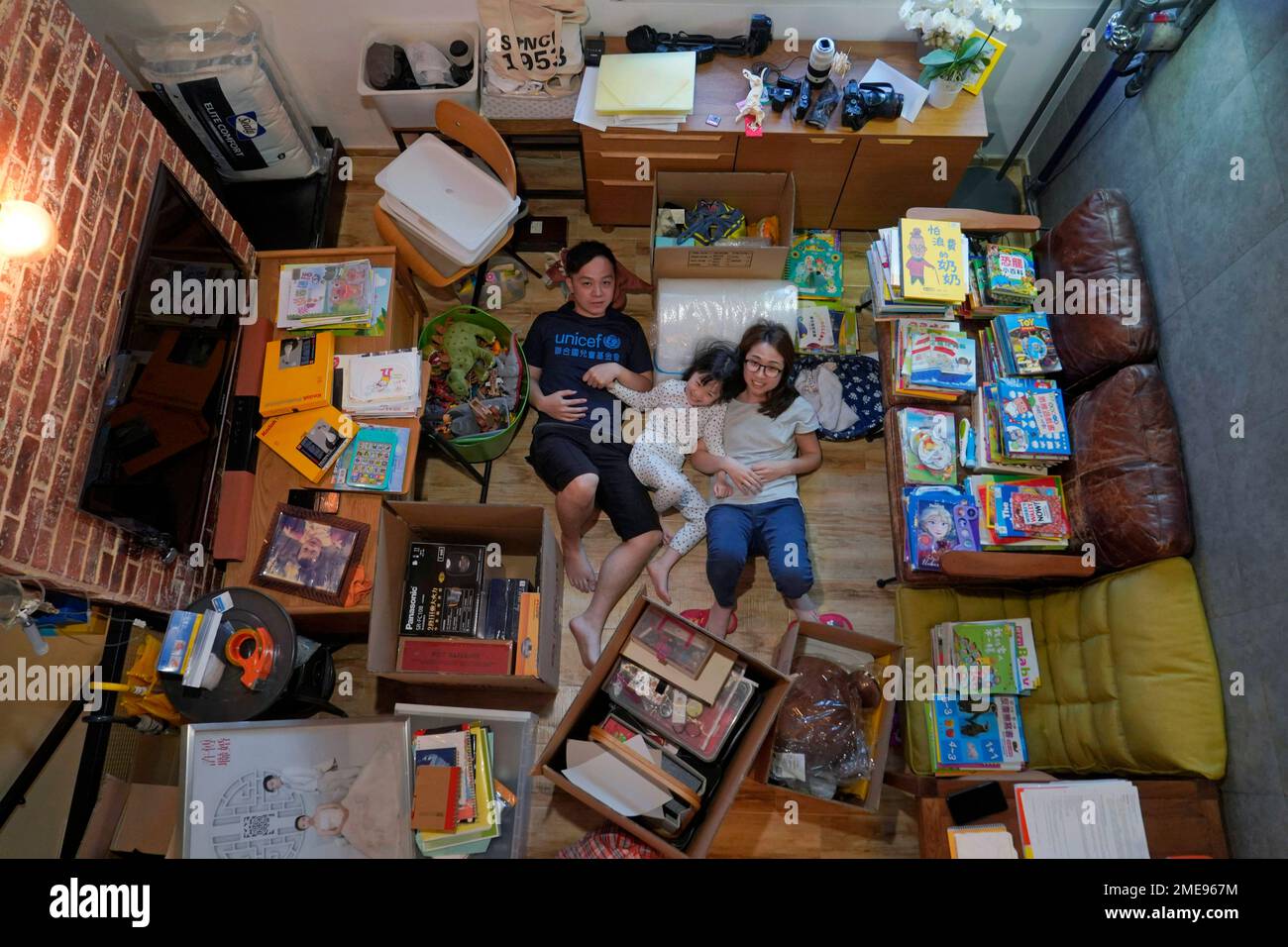 Mike Hui, left, poses with his family in Hong Kong as they are packing ...