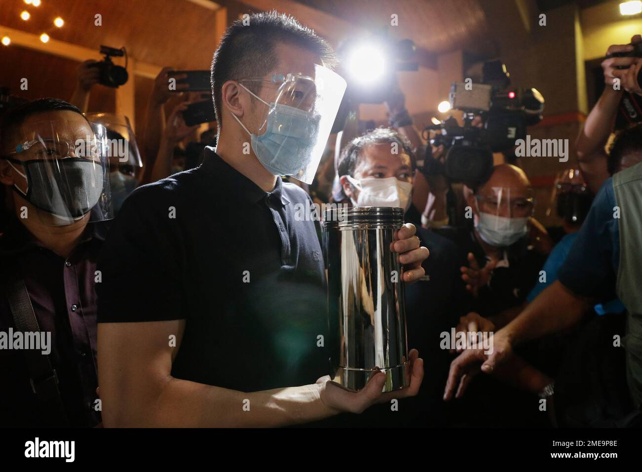 Miguel Abellada, carries the urn of his uncle, the former Philippine ...