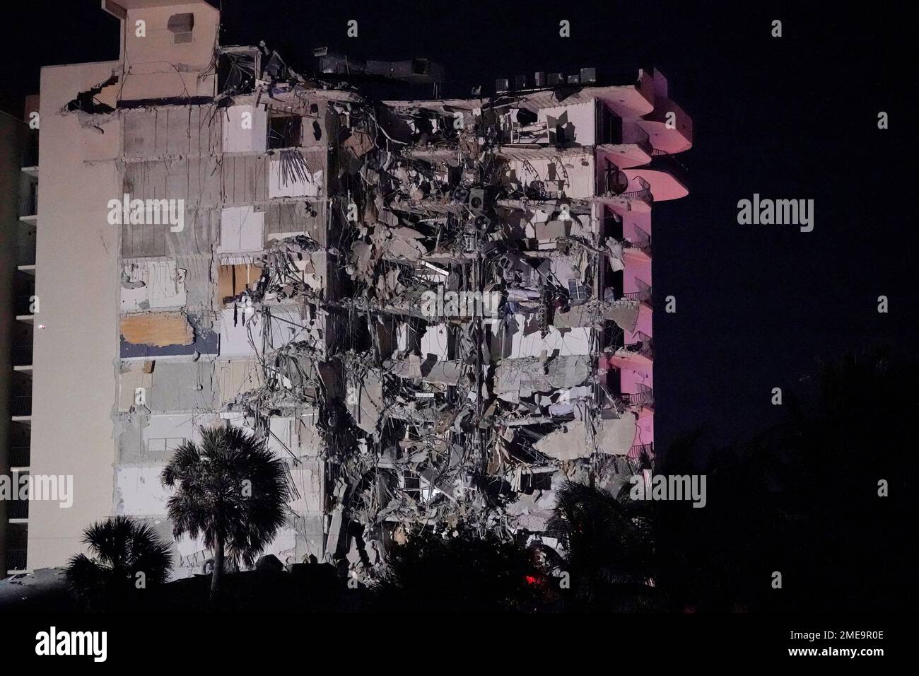 A partially collapsed building is seen early Thursday, June 24, 2021 ...