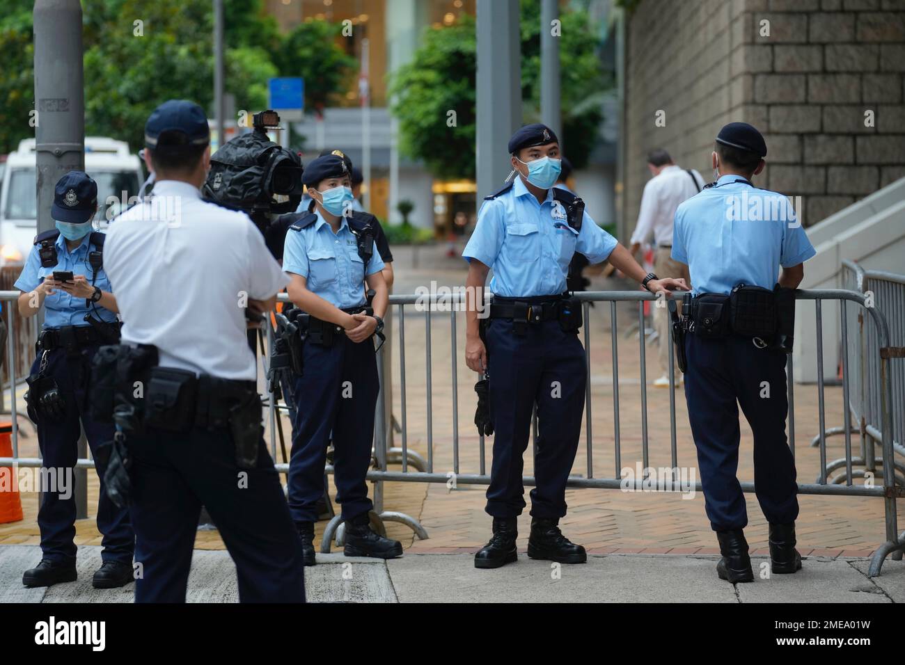 Police officers stand guard as Tong Ying-kit is arriving at a court in ...
