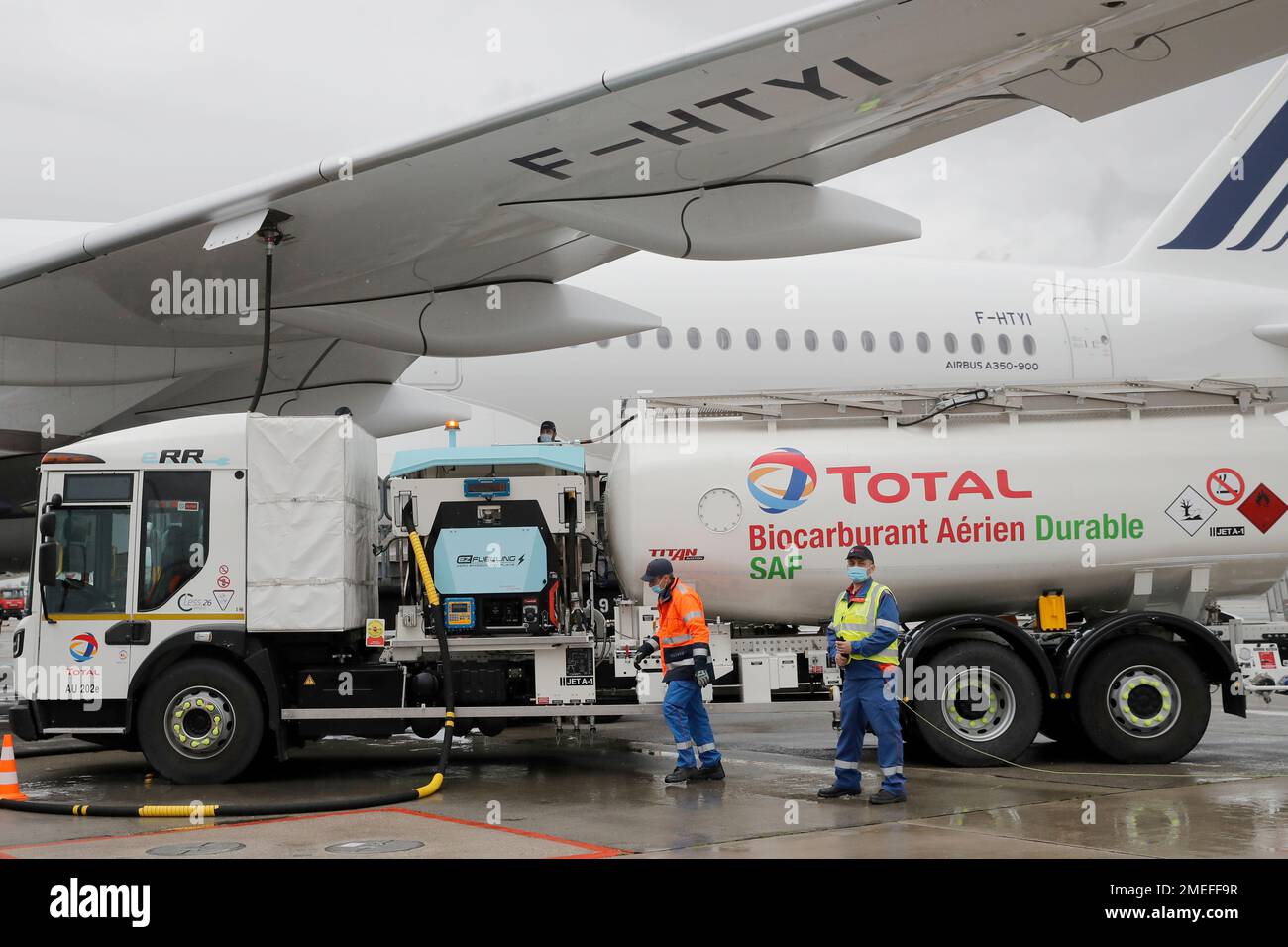 Workers refuel an Airbus A350 with sustainable aviation fuel at Roissy ...