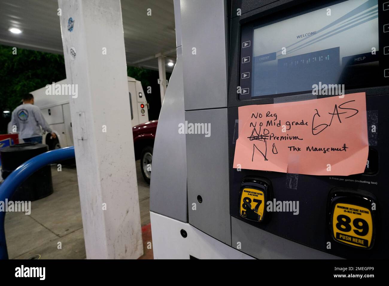 A hand written sign is posted on a gas pump, showing that the service ...
