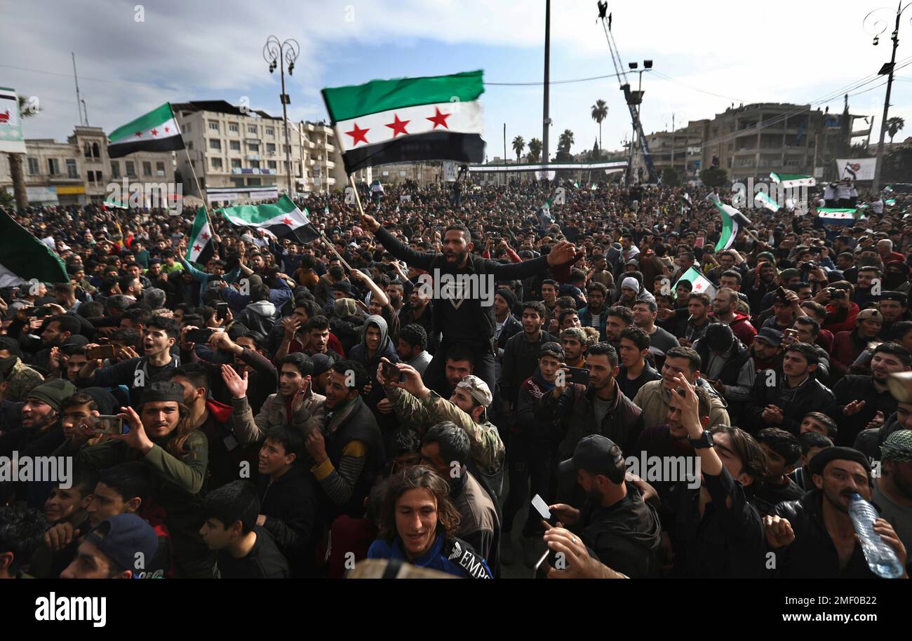 Thousands of anti-Syrian government protesters shout slogans and wave ...