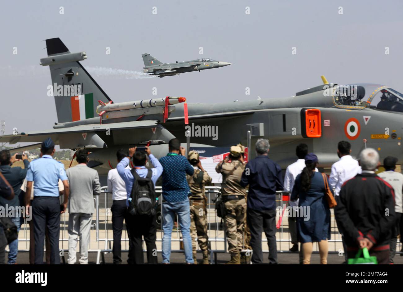 People watch Indian Air Force's Tejas fly over a Jaguar fighter ...