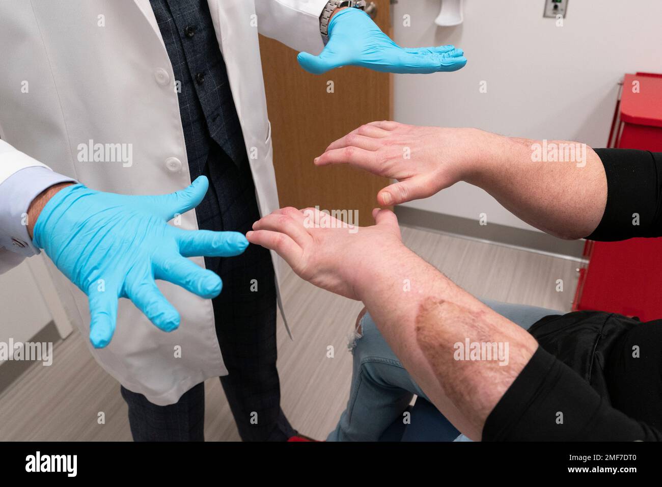 Joe DiMeo, right, demonstrates the flexibility in his fingers for Dr ...