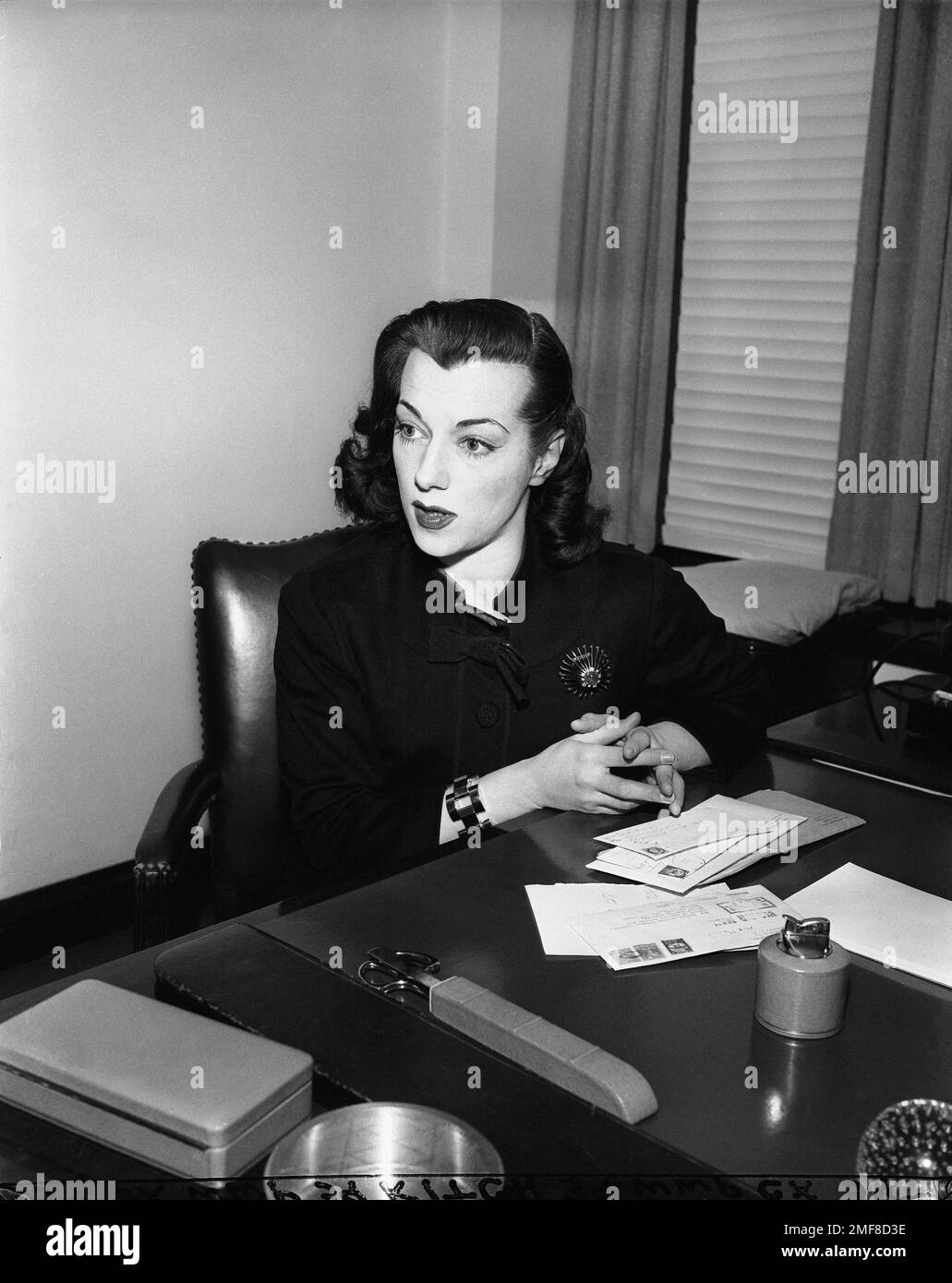 Mollie Netcher Bragno, sits at her desk, Feb. 28, 1955, in Chicago at ...