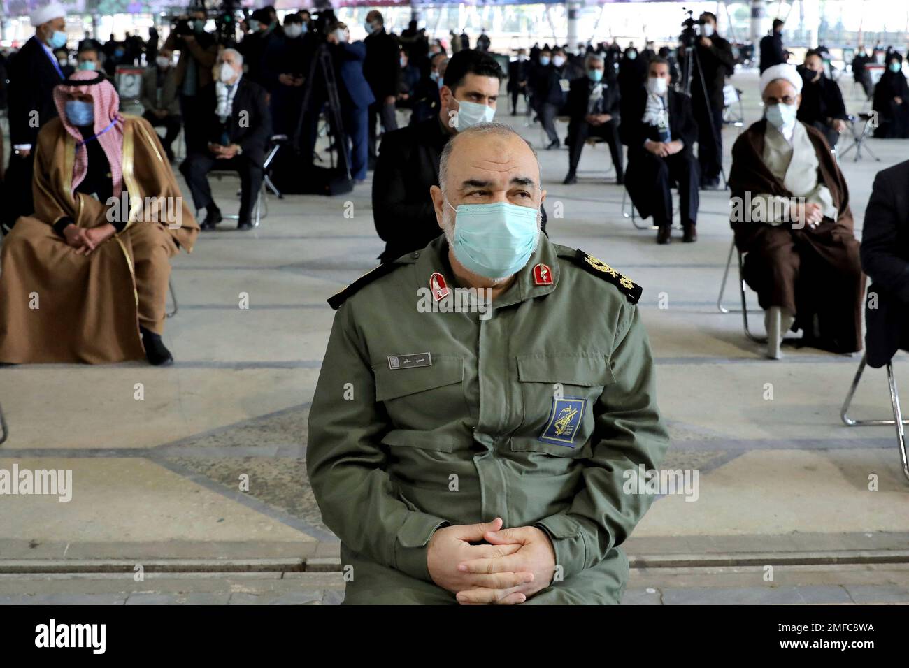 Chief of Iran's Revolutionary Guard Gen. Hossein Salami wearing a mask, attends a ceremony on ...