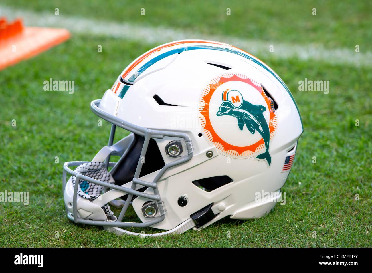A Miami Dolphins football helmet sits on the field as the Dolphins take ...
