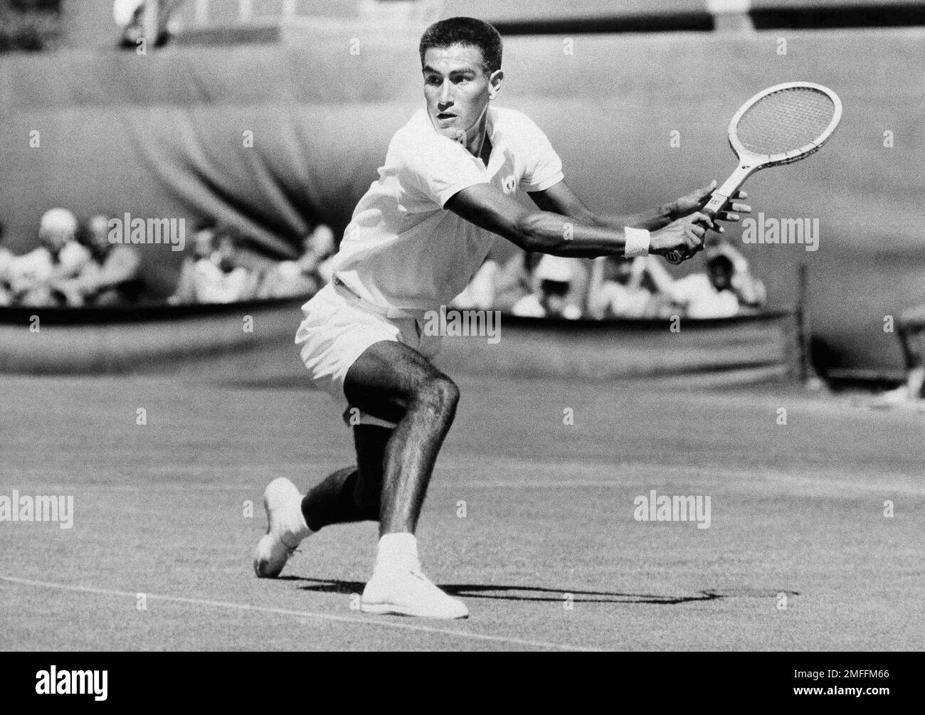 FILE - Alex Olmedo prepares to make a backhand return during a match ...