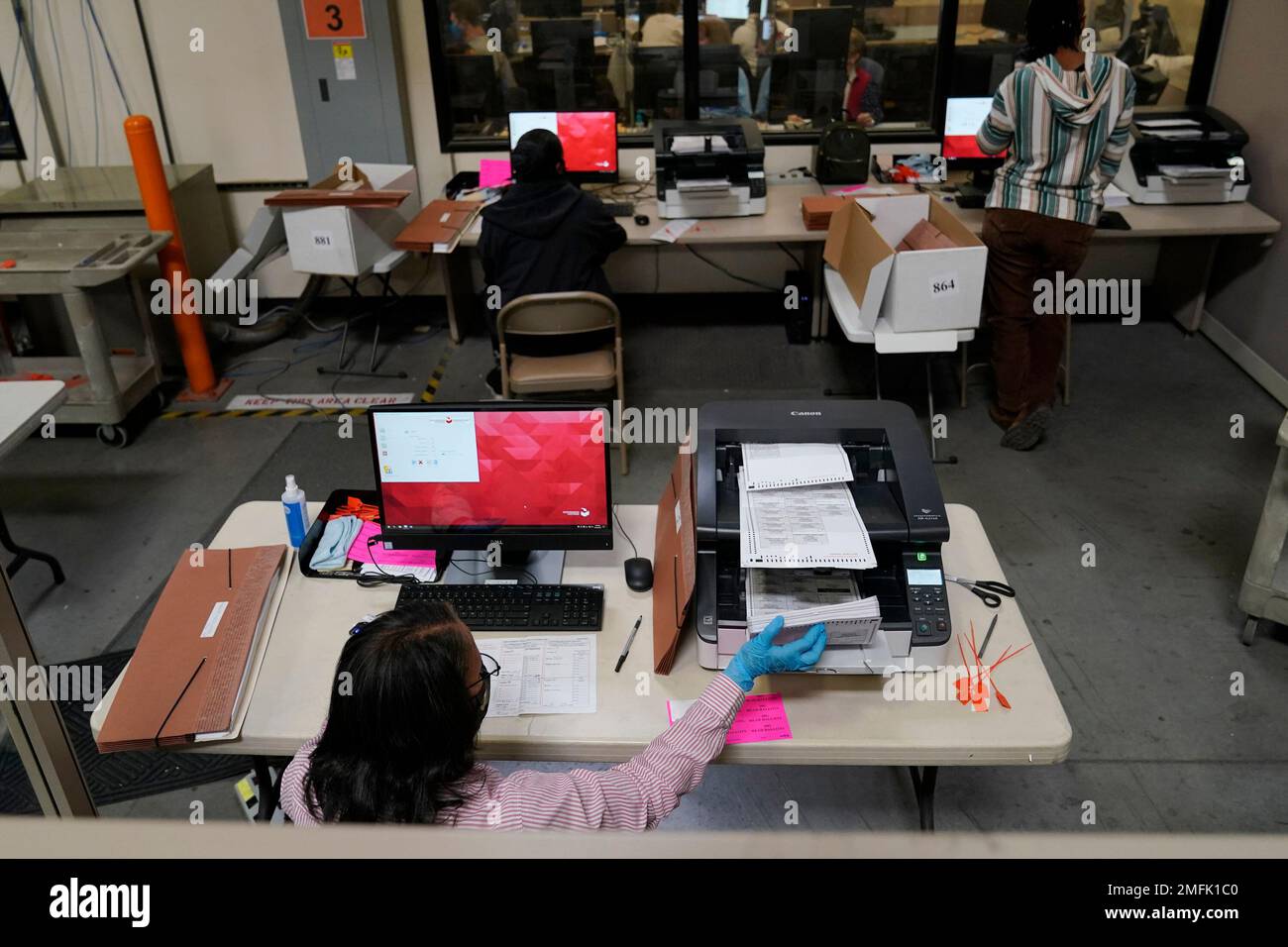 FILE - In this Oct. 29, 2020, file photo, a county worker loads mail-in ...