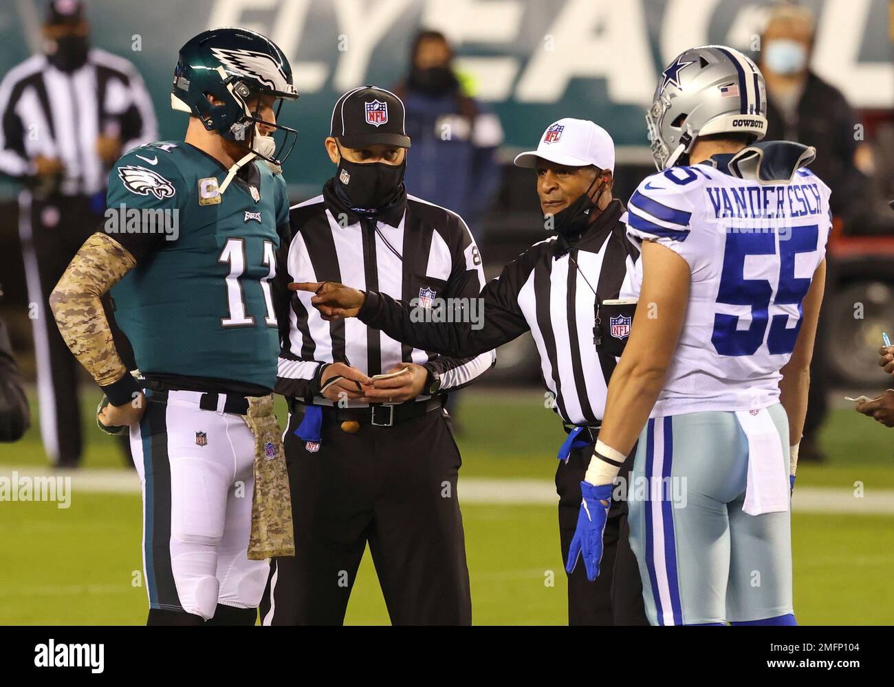 Referee Jerome Bogar (23) explains the coin flip with Philadelphia ...