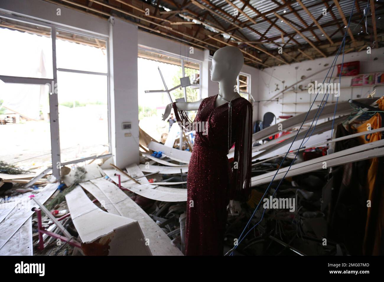 A mannequin inside a shop damaged by shelling during fighting over the ...