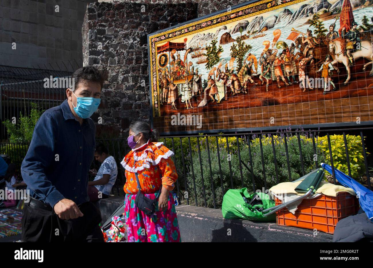 Locals walk past a mural dedicated to Spanish conquistador Hernan ...