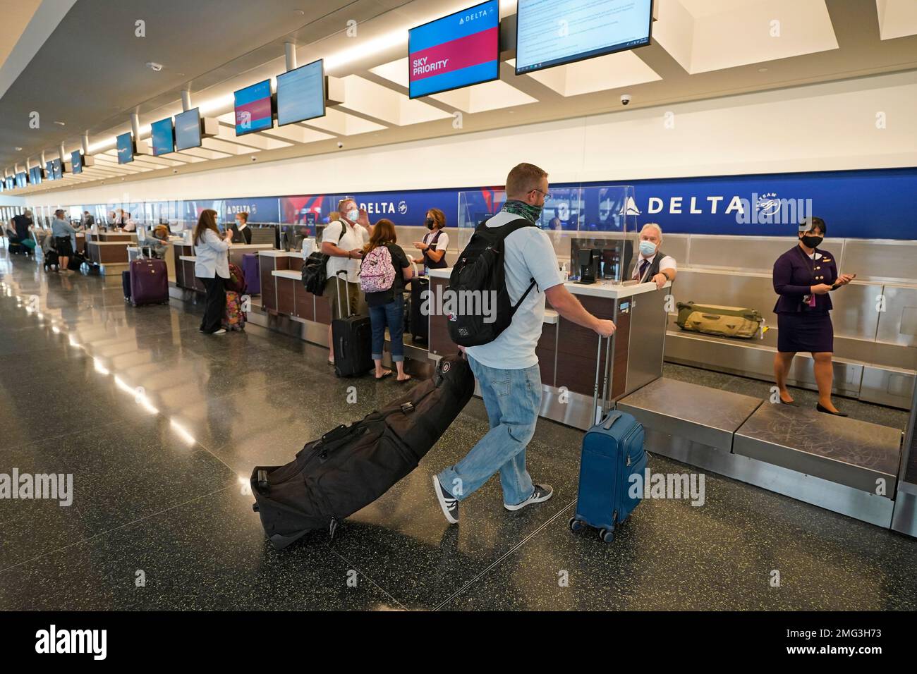 A passenger arrives at Delta's ticketing gate in the new terminal at ...