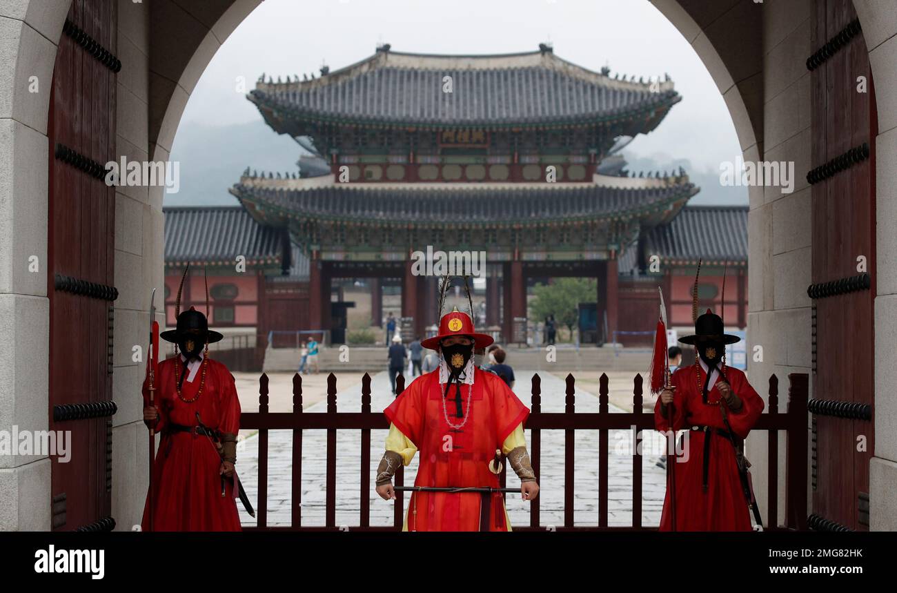 Workers wearing face masks stand during a re-enactment of the changing of the Royal Guard in ...